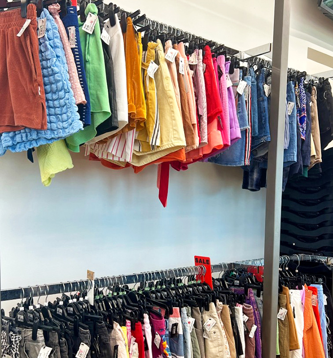 A rainbow of shorts and skirts organized by color, creating an Instagram-worthy display that makes shopping feel like curating art.