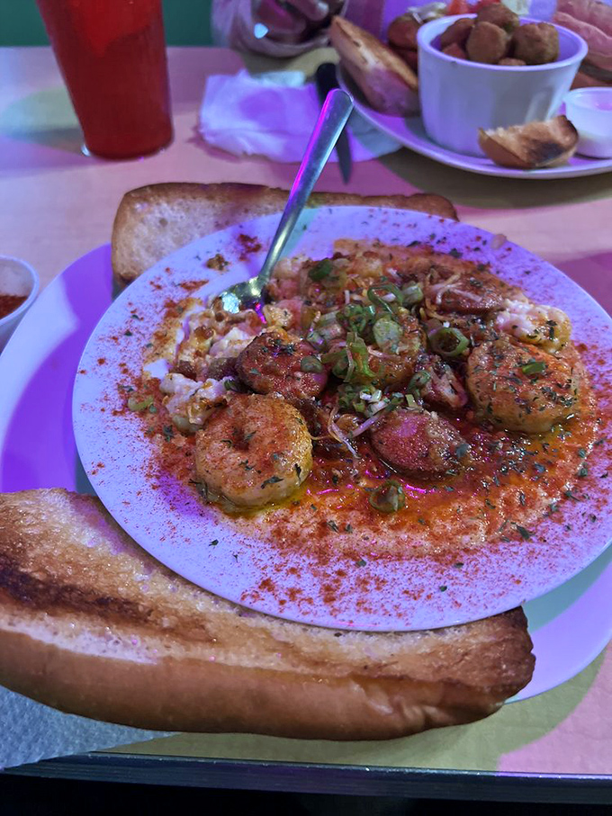 Cajun-spiced shrimp nestled on a bed of creamy grits with toast for dipping&mdash;Southern comfort food that feels like a warm hug.