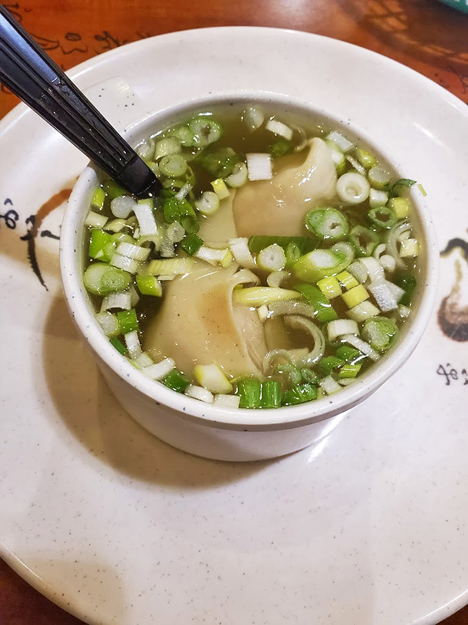 A steaming bowl of miso soup with green onions floating like little life rafts. The perfect opening act before the main event of sushi indulgence.