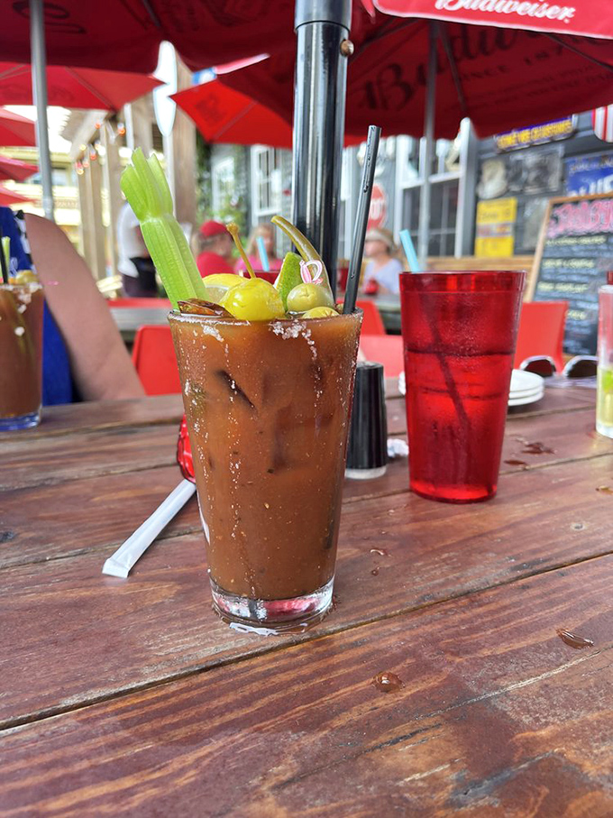 The Red Bar's Bloody Mary comes fully loaded like a Florida pickup truck—celery stalk, olives, and enough spice to wake up even the most stubborn vacation hangover.
