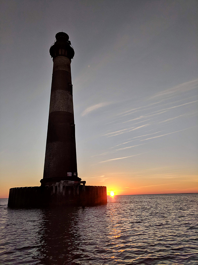 Sunset paints the lighthouse in amber hues, proving that even after 150 years, it still knows how to pose for a portrait.