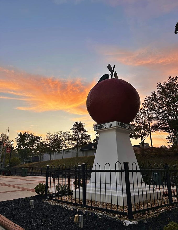 Sunset casts a golden glow on the Big Red Apple, transforming this quirky roadside attraction into something almost magical.
