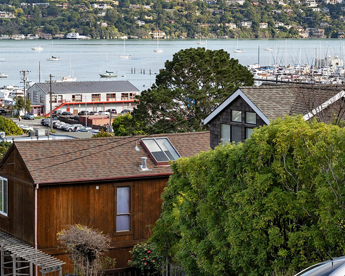 Wooden homes with weathered charm perch above the bay, offering glimpses of the maritime world below.