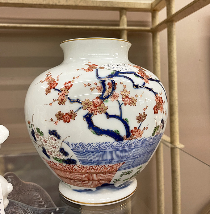 This porcelain vase doesn't just hold flowers; it holds centuries of artistic tradition in its delicate blue and coral brushstrokes.