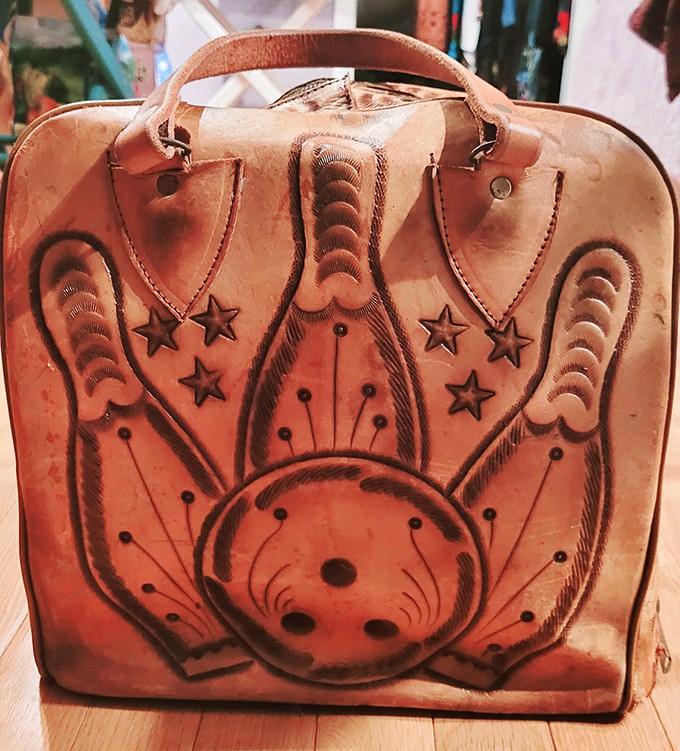 This bowling bag isn't just vintage leather&mdash;it's wearable art from an era when even sports accessories had personality.