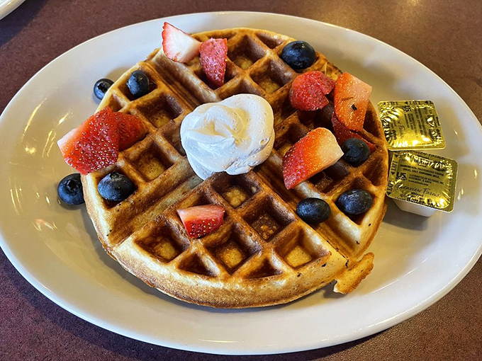 Not just any waffle&mdash;a canvas of golden perfection topped with fresh berries and a dollop of cream that turns breakfast into an occasion worth celebrating.