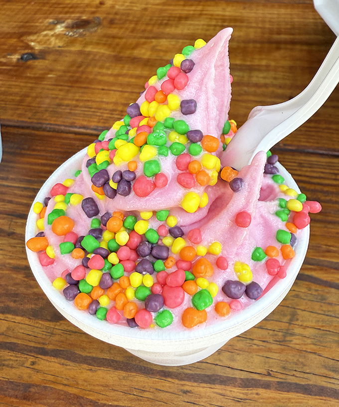 Pink frozen joy topped with rainbow crunch. This dessert doesn't care about your diet, and for a few blissful minutes, neither will you.
