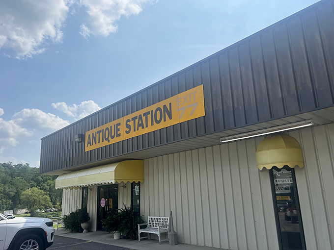 Antique Station's bright yellow sign stands out against the blue sky &ndash; a cheerful beacon for vintage enthusiasts.