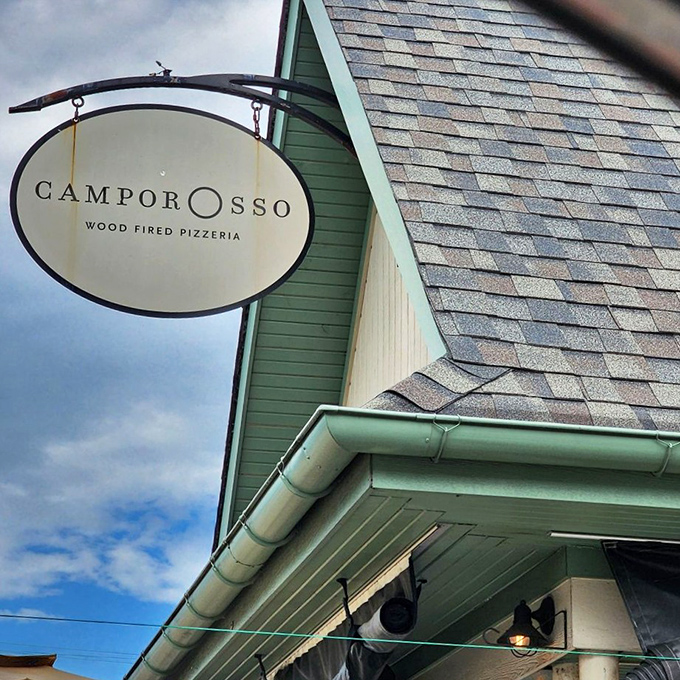 Camporosso's elegant hanging sign swings gently in the breeze, promising wood-fired delights within.
