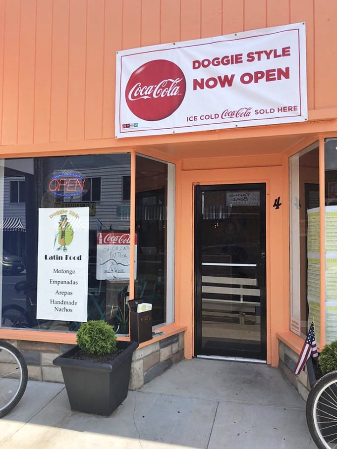 Bold orange storefront promises bold flavors inside this beachside hot dog haven.