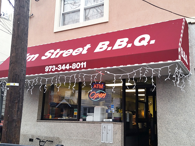 Elm Street BBQ's modest storefront hides Newark's smoky treasures. That simple red awning marks the spot where BBQ magic happens.