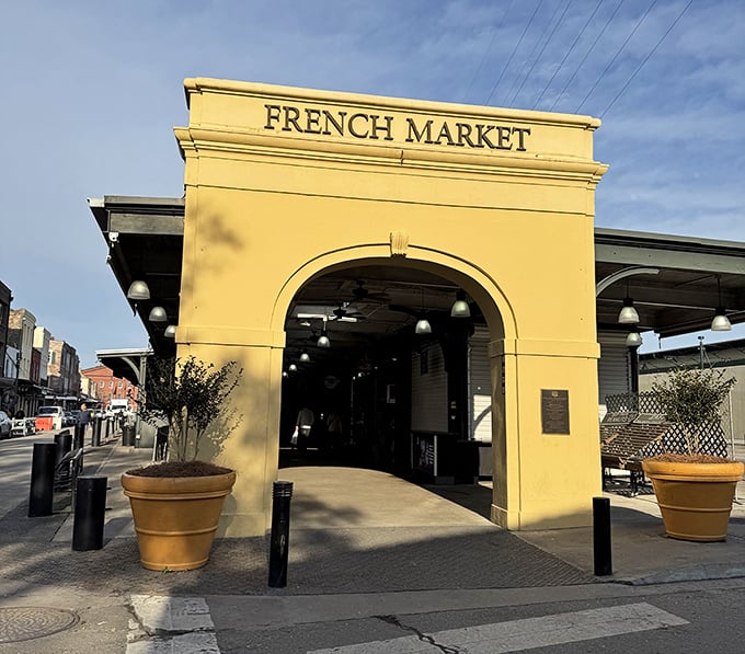 The historic yellow archway welcomes visitors like an old friend opening their door wide.