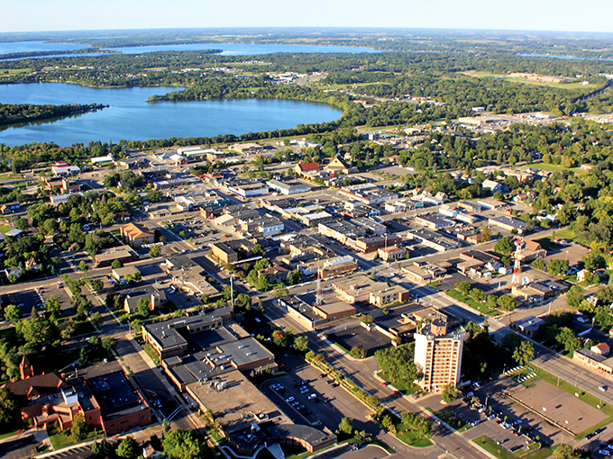 An aerial view of Grand Rapids showcases its scenic blend of lakes, tree-lined neighborhoods, and a vibrant downtown core.