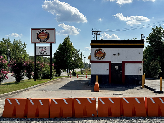 Hot Dog Depot's compact white building with bold signage stands like a tasty lighthouse, guiding hungry souls to hot dog salvation.