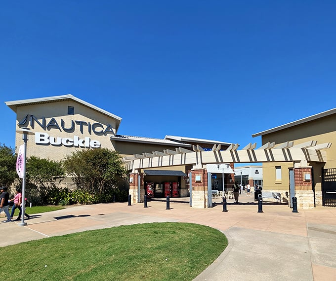 This landscaped entrance feels more like arriving at a resort than an outlet center, complete with manicured lawns and welcoming signage.
