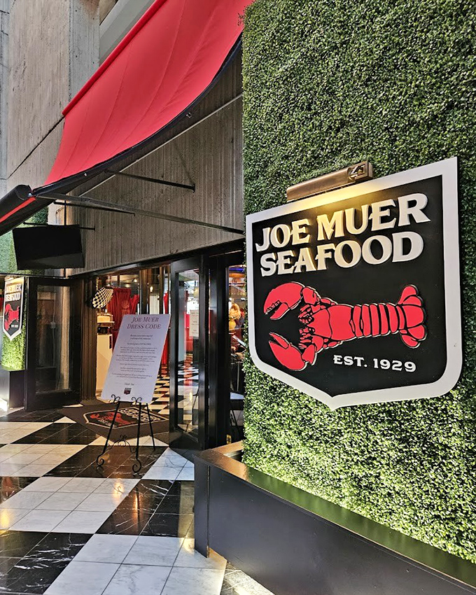 That iconic red lobster sign against the living green wall is like a culinary traffic light saying "Stop and eat here!"