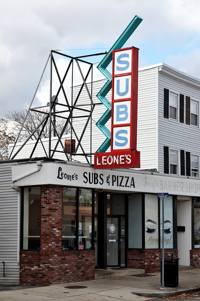 Leone's neon sign cuts through the night like a pizza beacon. That zigzag design? Pure retro charm!