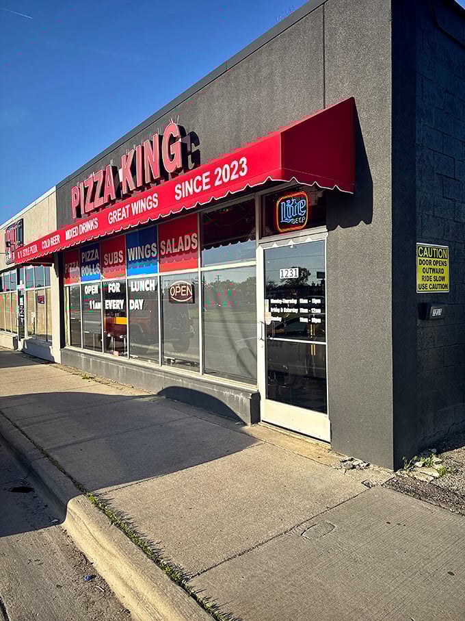 Pizza King's bold red signage makes a royal proclamation: serious pizza happens here.