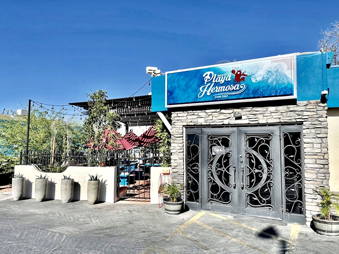 Mariscos Playa Hermosa's vibrant blue sign and ornate doors transport you to a Mexican coastal getaway.