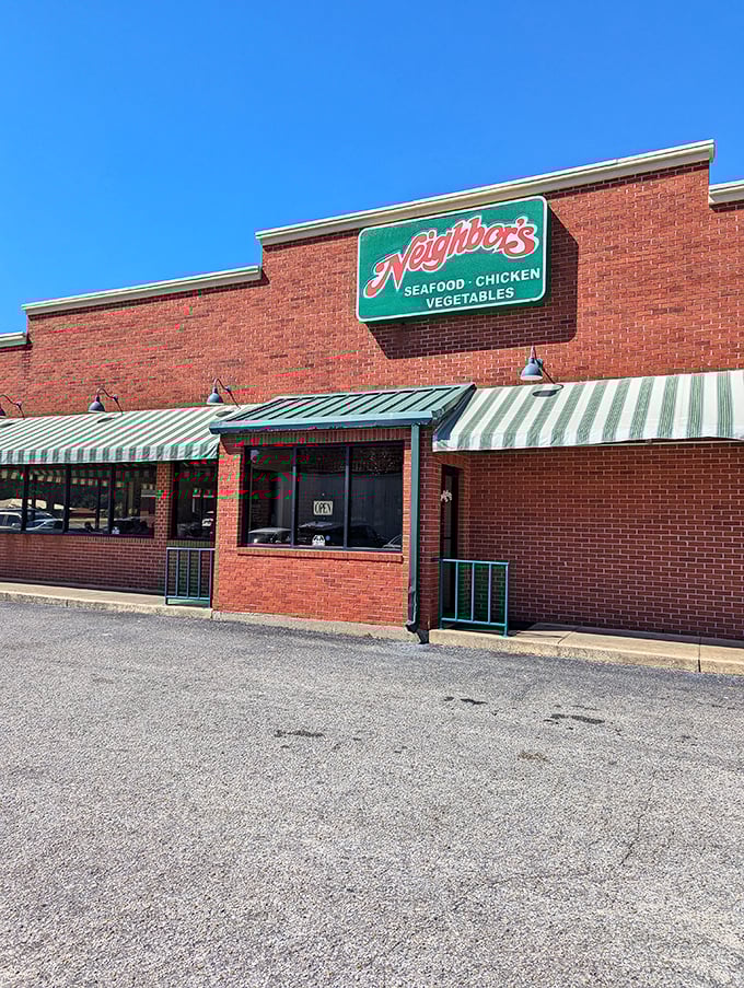 Neighbor's classic brick building with green awnings looks like it belongs in a movie about Southern food.