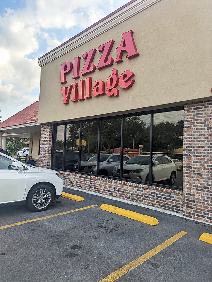 Pizza Village's bold sign cuts through any confusion&mdash;you're here for serious pizza business. No frills, just thrills for your taste buds.