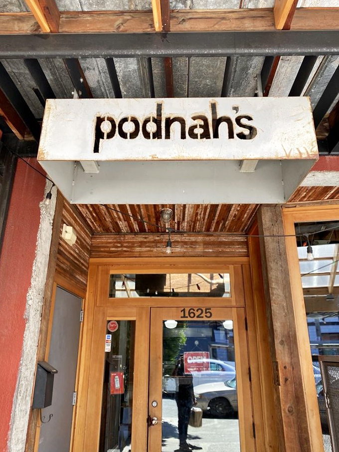 The pathway to Podnah's BBQ promises smoky delights ahead. Simple exterior, extraordinary flavors waiting just beyond those wooden doors.