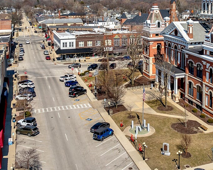 Pontiac's downtown showcases a beautiful courthouse surrounded by historic buildings, with vintage cars adding to the nostalgic feel.