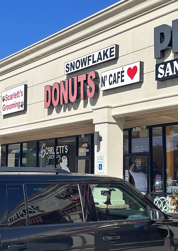 Snowflake Donuts' clean storefront with its heart logo is like the friendly neighbor who always has treats. The kind of place where calories don't count because they're made with love.