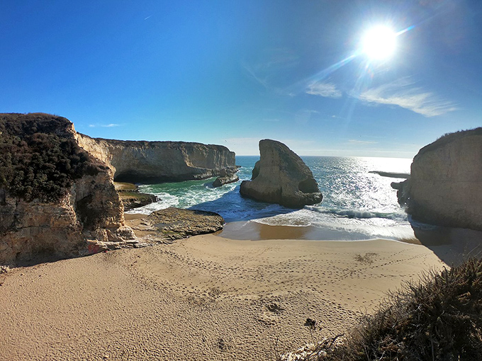 The iconic shark fin rock stands sentinel at this hidden cove, creating California's most distinctive coastal silhouette.