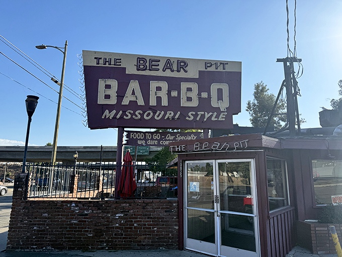 The Bear Pit's vintage sign has guided hungry travelers to Missouri-style BBQ for generations.