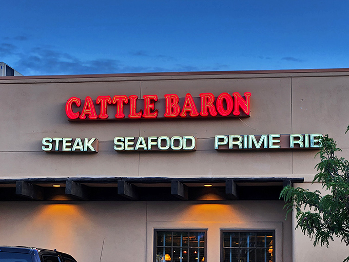 Cattle Baron's glowing sign cuts through the evening sky like a beacon for the beef-obsessed. Prime rib dreams start here!