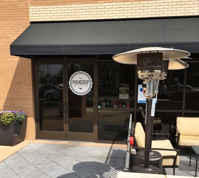 The Manship's elegant entrance hints at wood-fired sophistication where pizza becomes art and dining becomes an experience.