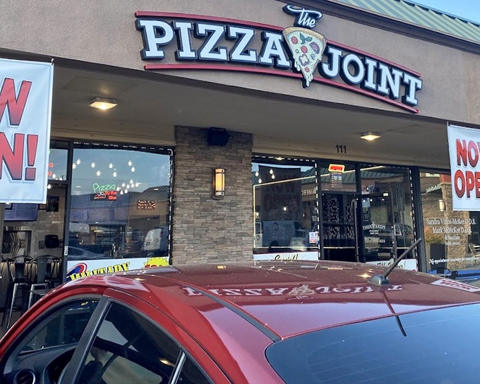 The Pizza Joint's modern storefront promises fresh ingredients and neighborhood warmth in every perfectly crafted slice. 