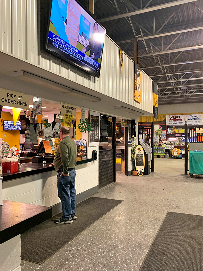 Urban archaeology in action. Shoppers sift through layers of American culture displayed on tables and blankets at Trader Jack's.