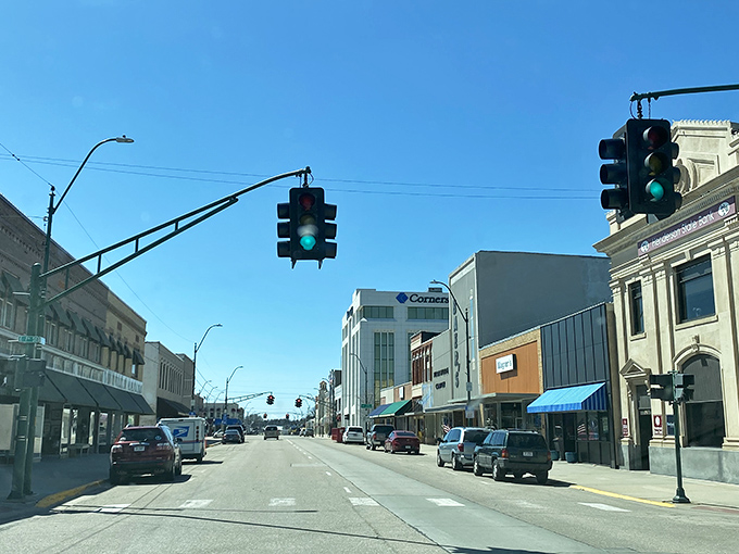 York's main drag dazzles! Where traffic lights hang like modern art installations and CornerStone's glass reflects dreams of small-town prosperity.