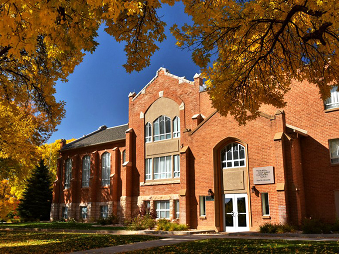 Mount Pleasant's historic school building stands proud against autumn foliage, a brick testament to community values.