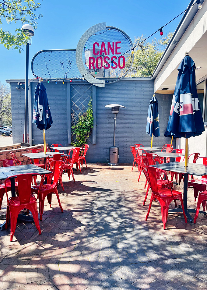 Red chairs dot Cane Rosso's inviting patio. Fort Worth pizza lovers know this is where Neapolitan magic happens under Texas skies.