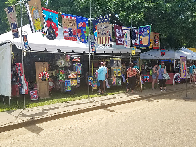 Vendor displays overflow with handmade goods and treasures while colorful flags wave overhead like celebration bunting at a party.