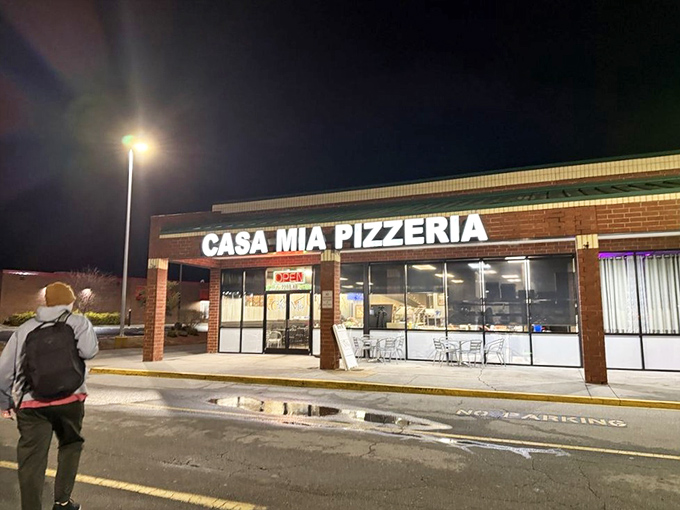 Night or day, Casa Mia's bright sign beckons pizza lovers with the promise of perfectly melted cheese.