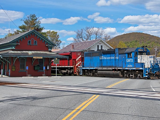 The blue locomotive passing Chester's vintage station offers a splash of modern color against classic New England architecture.