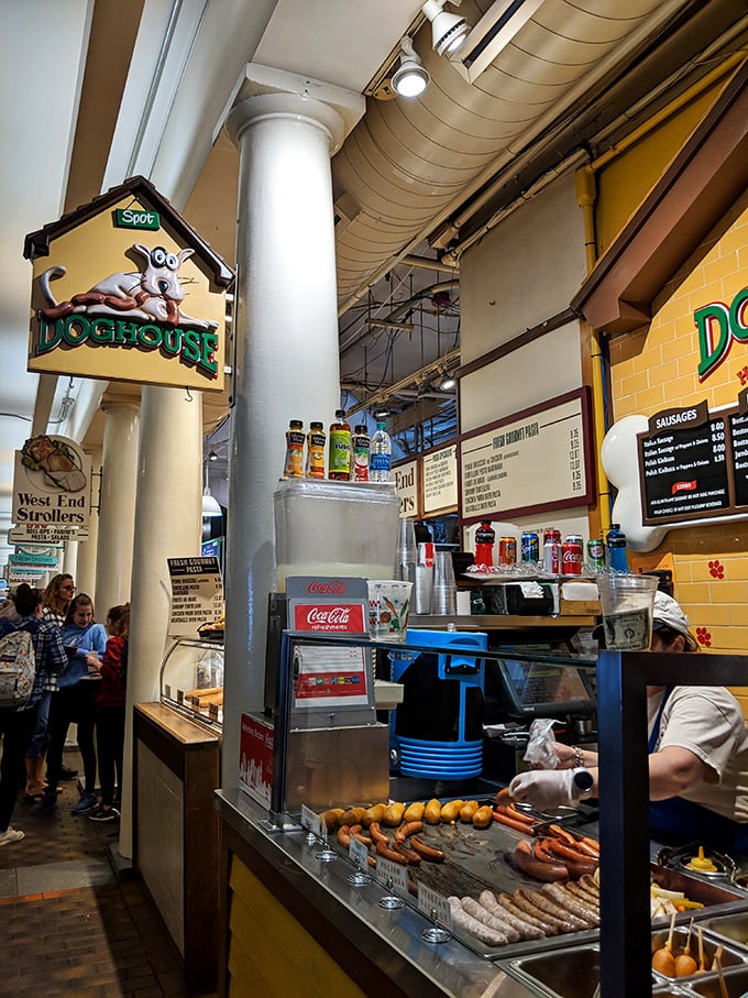 The market's bustling energy provides the perfect backdrop for this tiny hot dog haven tucked among historic columns.