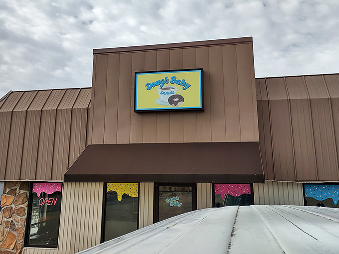 The colorful window displays hint at the rainbow of donut options waiting inside this sweet small-town treasure.