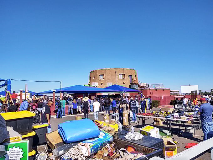 Crowd-surfing for deals! Glendale's round brick building draws treasure hunters like moths to flame, while foreground bins overflow with possibilities under that famous Arizona blue.