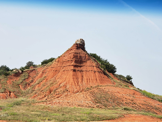 This crimson peak stands proud as a natural monument, older and more impressive than Mount Rushmore.