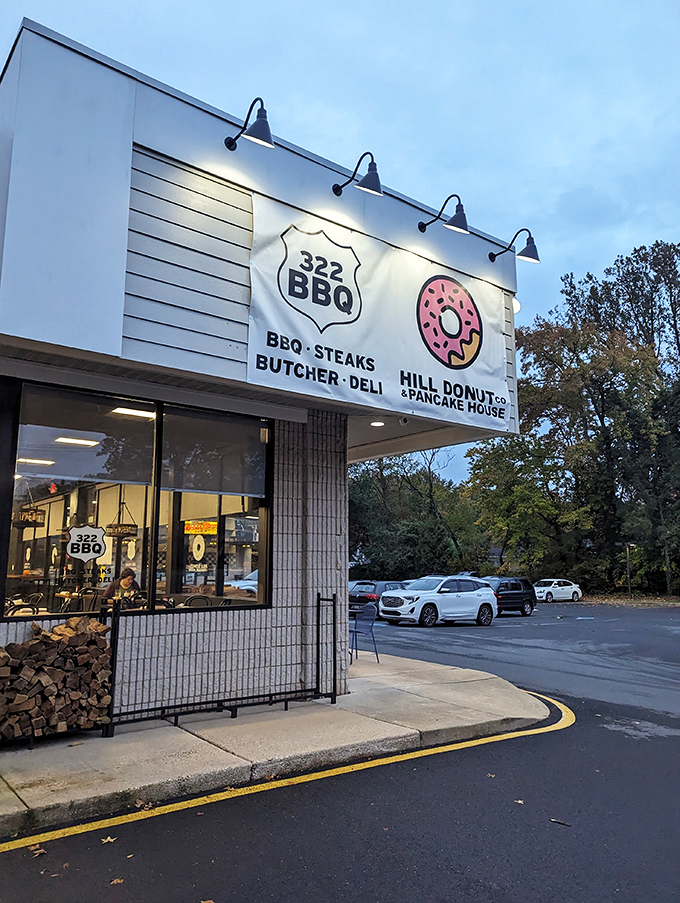 As evening falls, the Hill Donut sign glows like a beacon for those seeking sweet satisfaction after dinner.