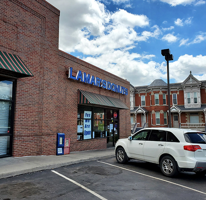Even on cloudy days, LaMar's blue signage stands out like a beacon guiding hungry travelers to glazed perfection.