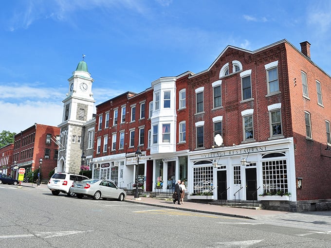 Litchfield's downtown showcases a distinctive clock tower, brick storefronts, and the Village Restaurant - quintessential small-town New England charm.