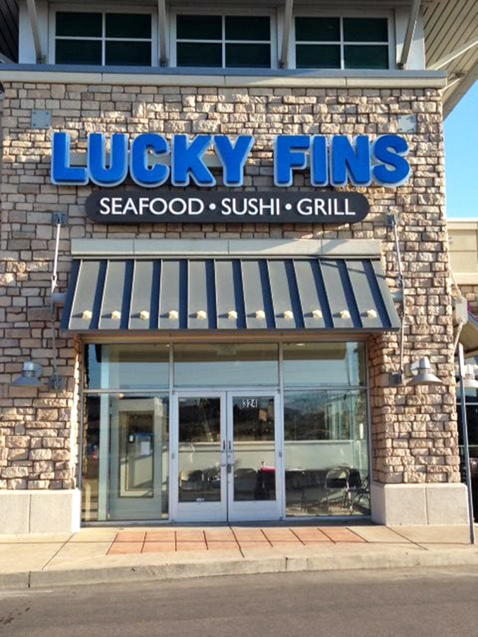 The stone facade and bright blue sign of Lucky Fins stand out like a coastal oasis in Greeley.