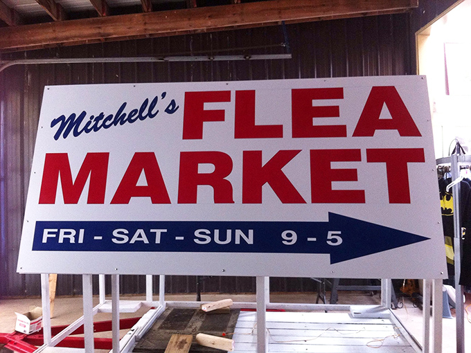Mitchell's Flea Market sign points the way to weekend adventures where thirty bucks can feel like three hundred.