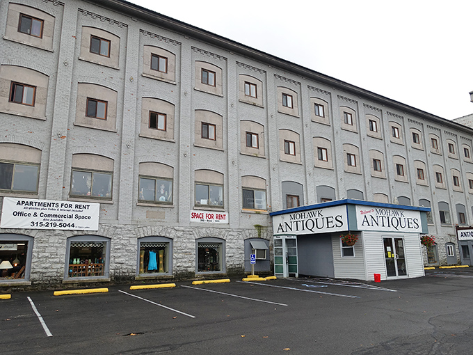 The contrast between modern storefront and historic factory creates the perfect metaphor for antiques themselves—old treasures in new contexts.